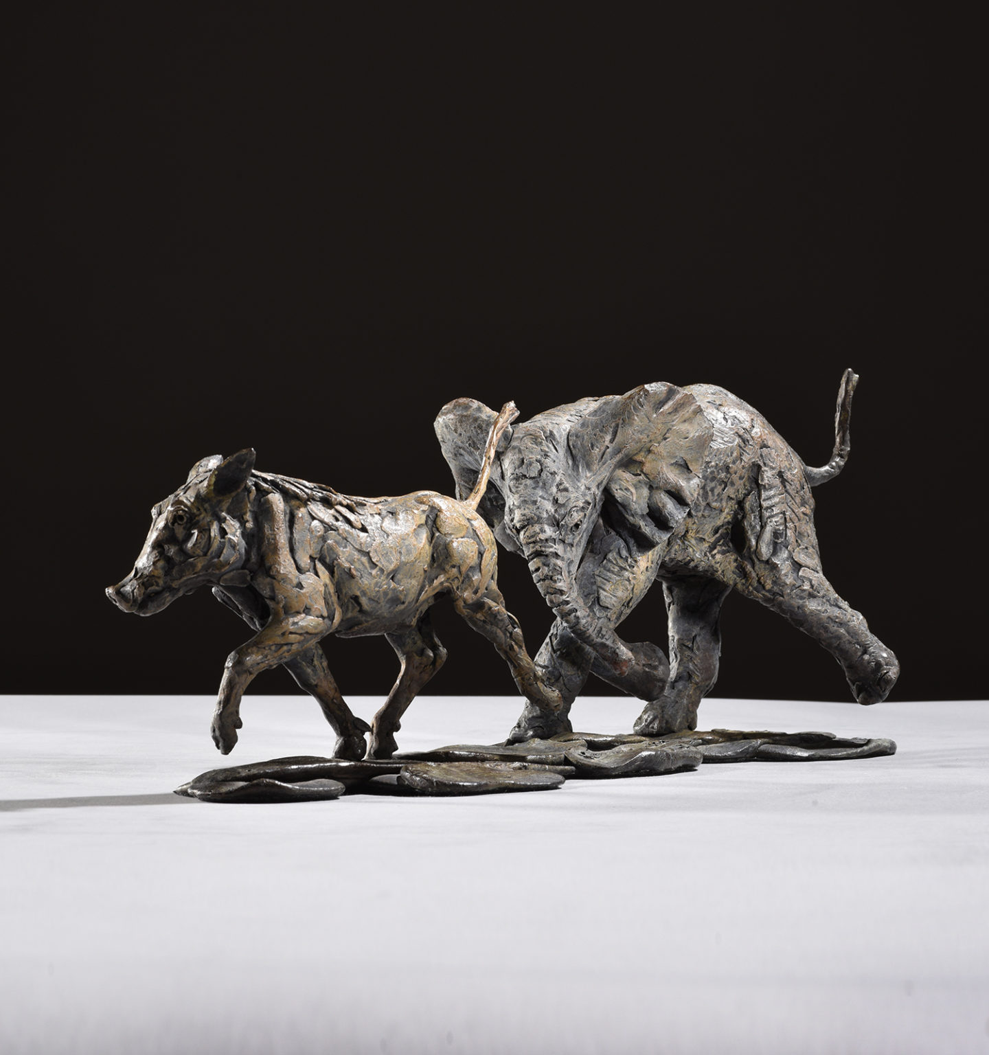Mackie's bronze sculpture of Elephant Calf chasing Warthog